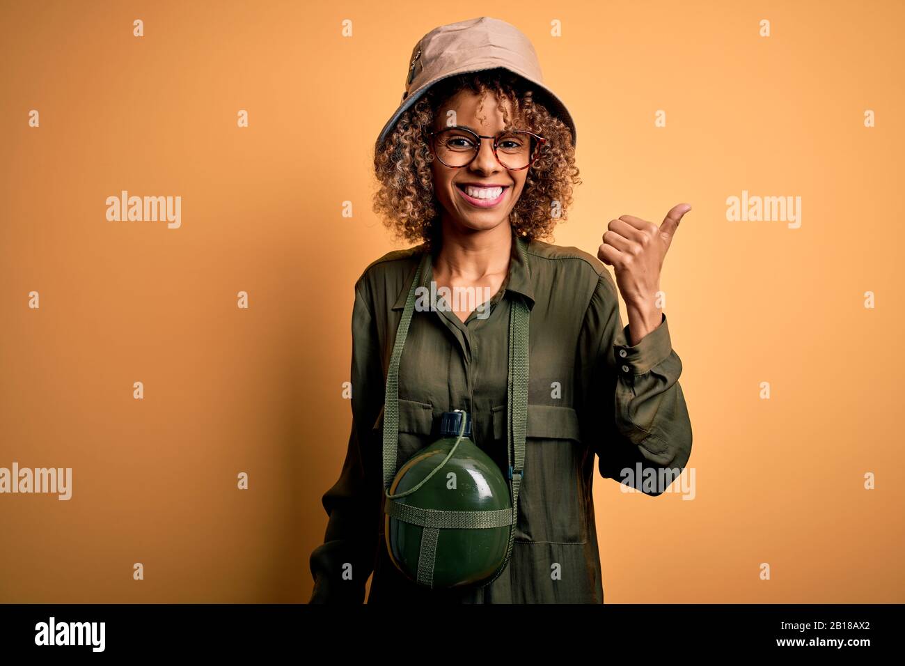 Young african american tourist woman on vacation wearing explorer hat ...