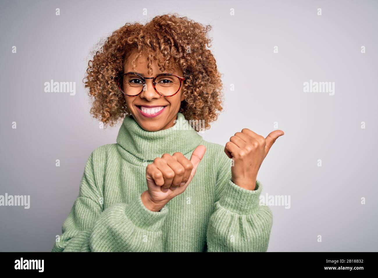 Young beautiful african american woman wearing turtleneck sweater and ... Young beautiful african american woman wearing turtleneck sweater and ...