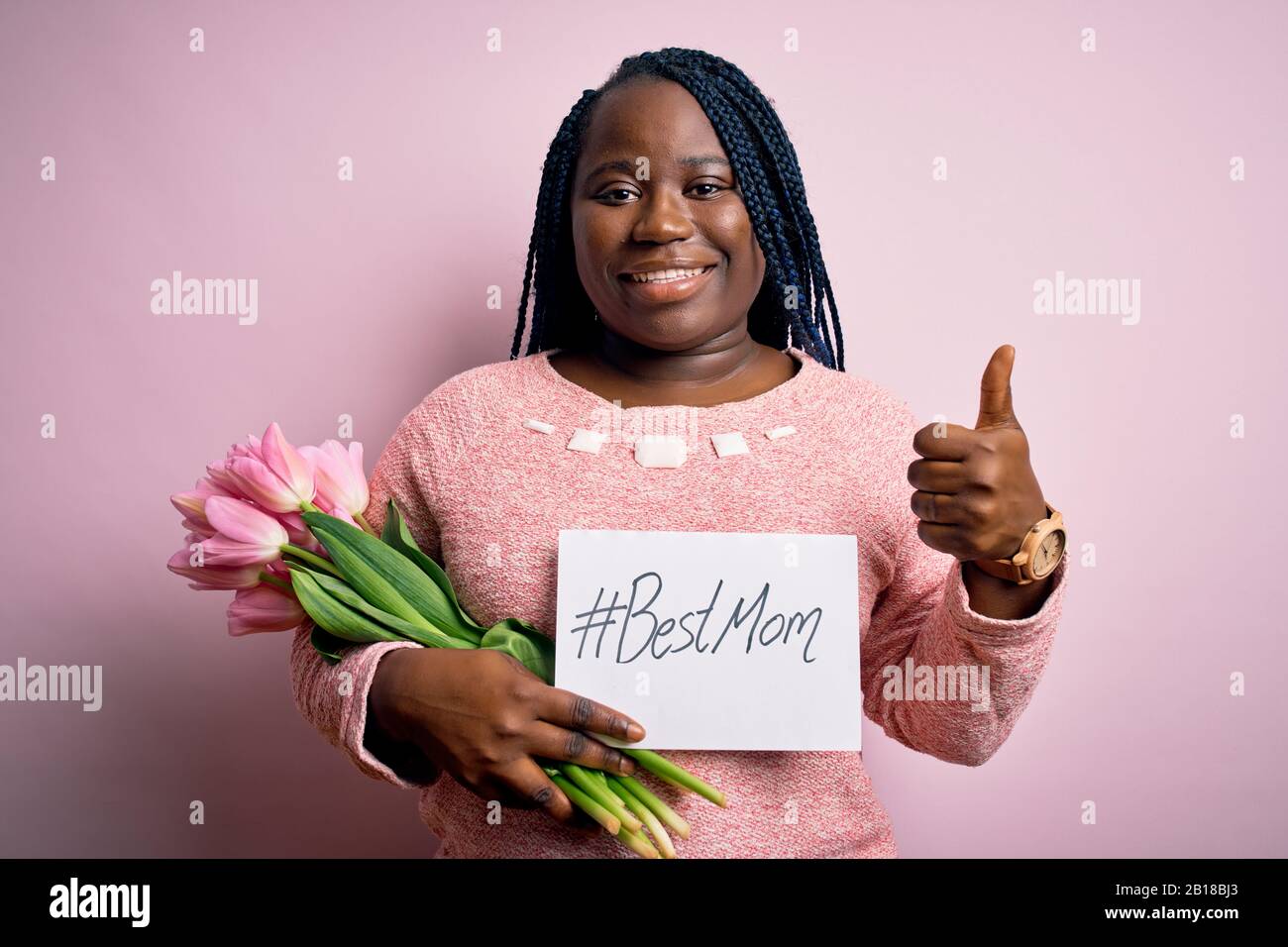 Plus size african american woman holding best mom message and tulips on ...