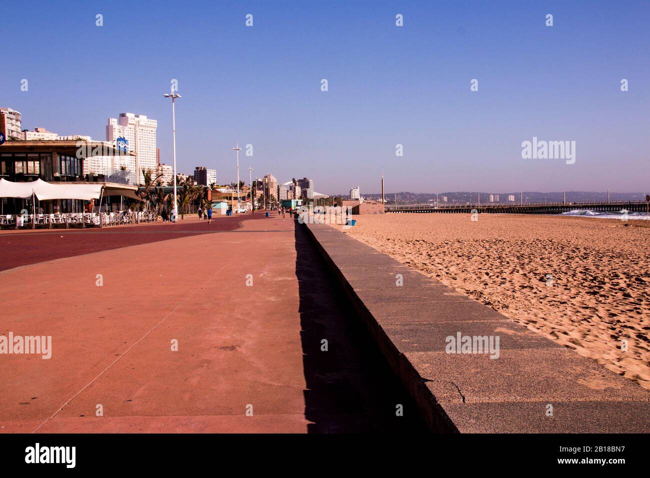 View of pedestrian walkway bordering beach at durban, south africa ...