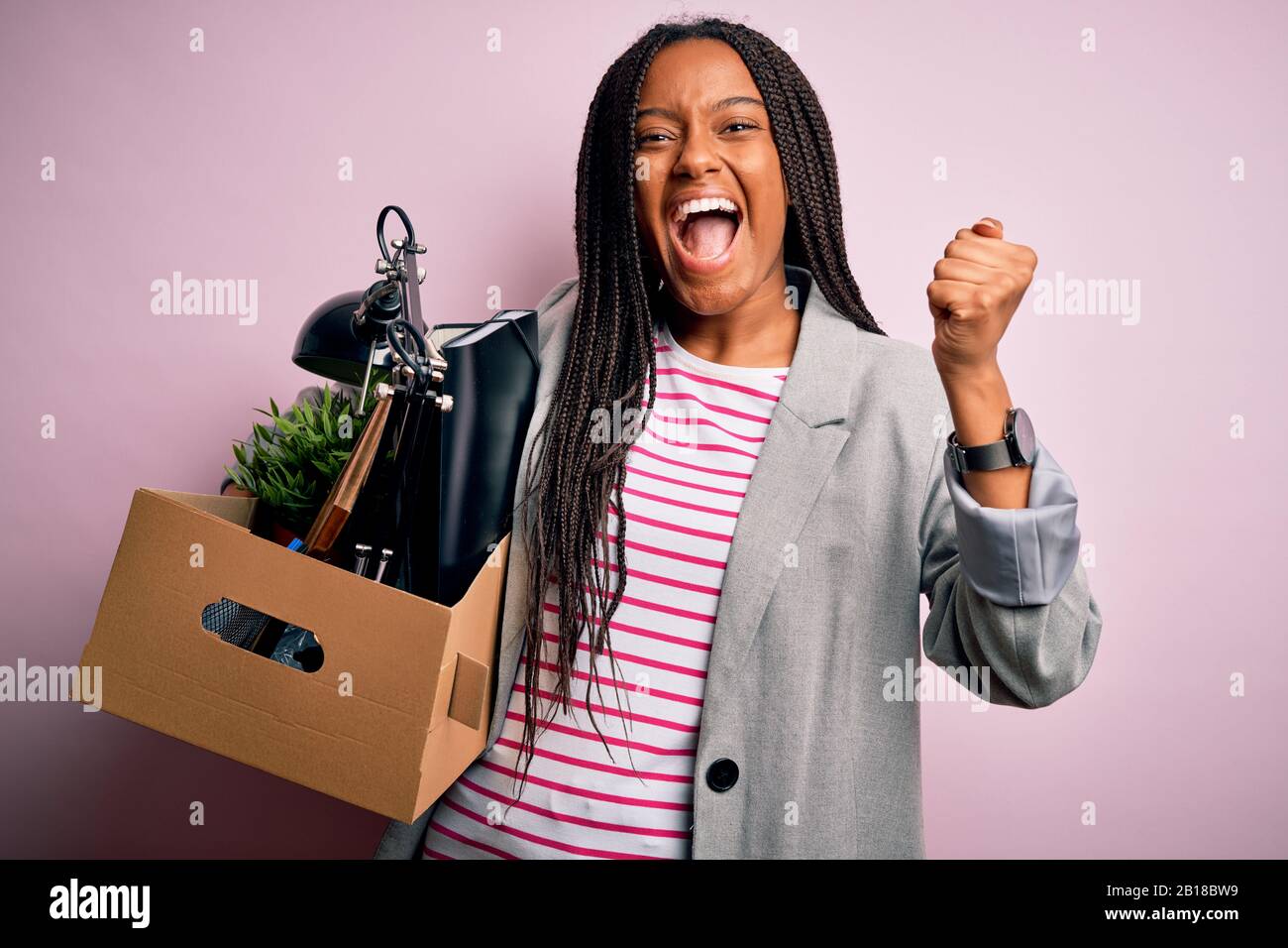 Young african american worker girl holding office cardboard fired from ...