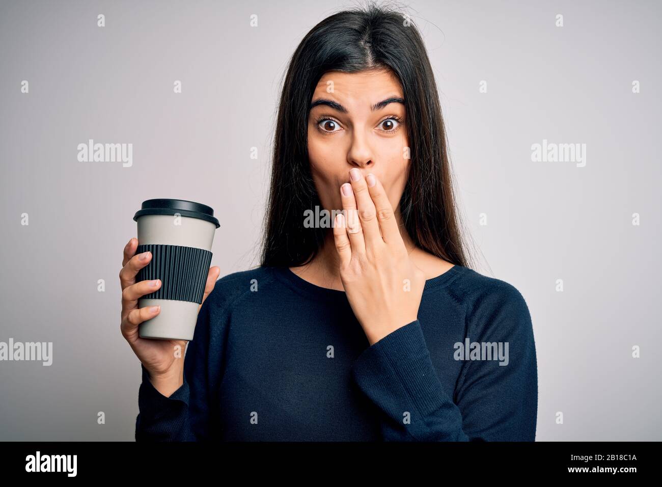 Young beautiful brunette woman drinking cup of coffee over isolated ...