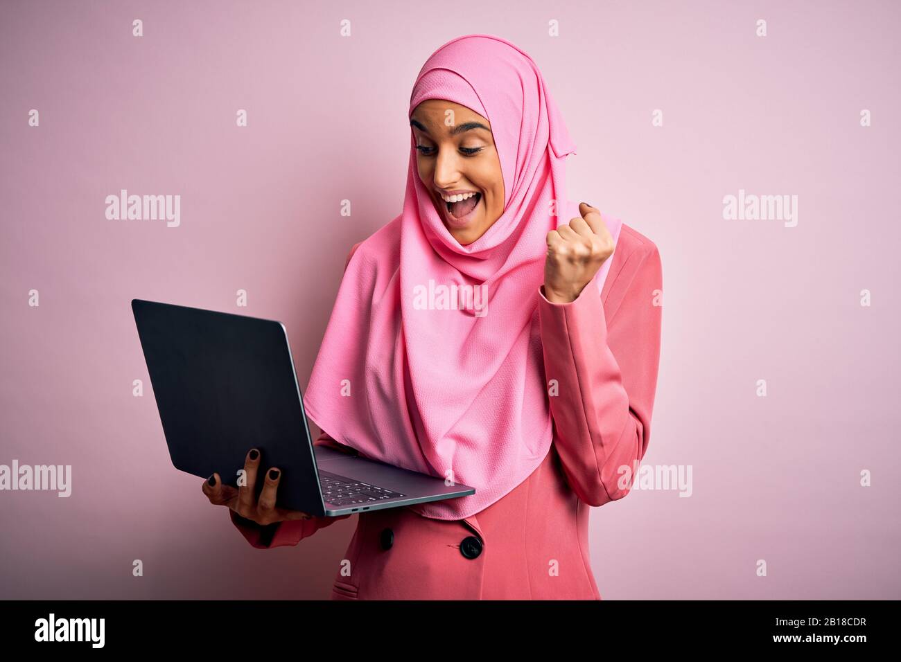 Young beautiful businesswoman wearing pink muslim hijab and business ...