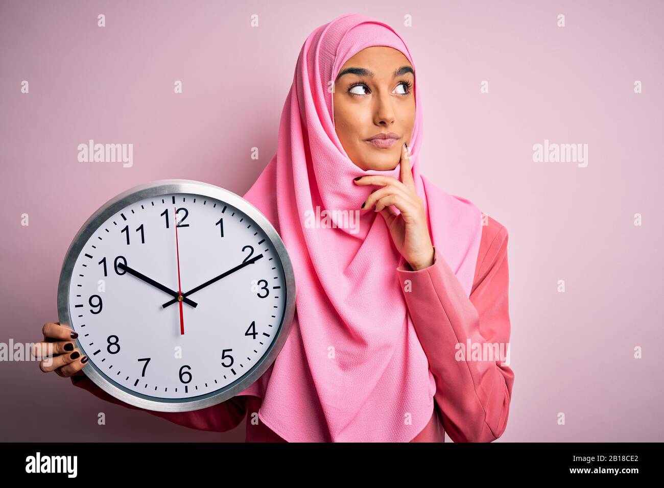 Young beautiful arab woman wearing pink muslim hijab doing countdown ...