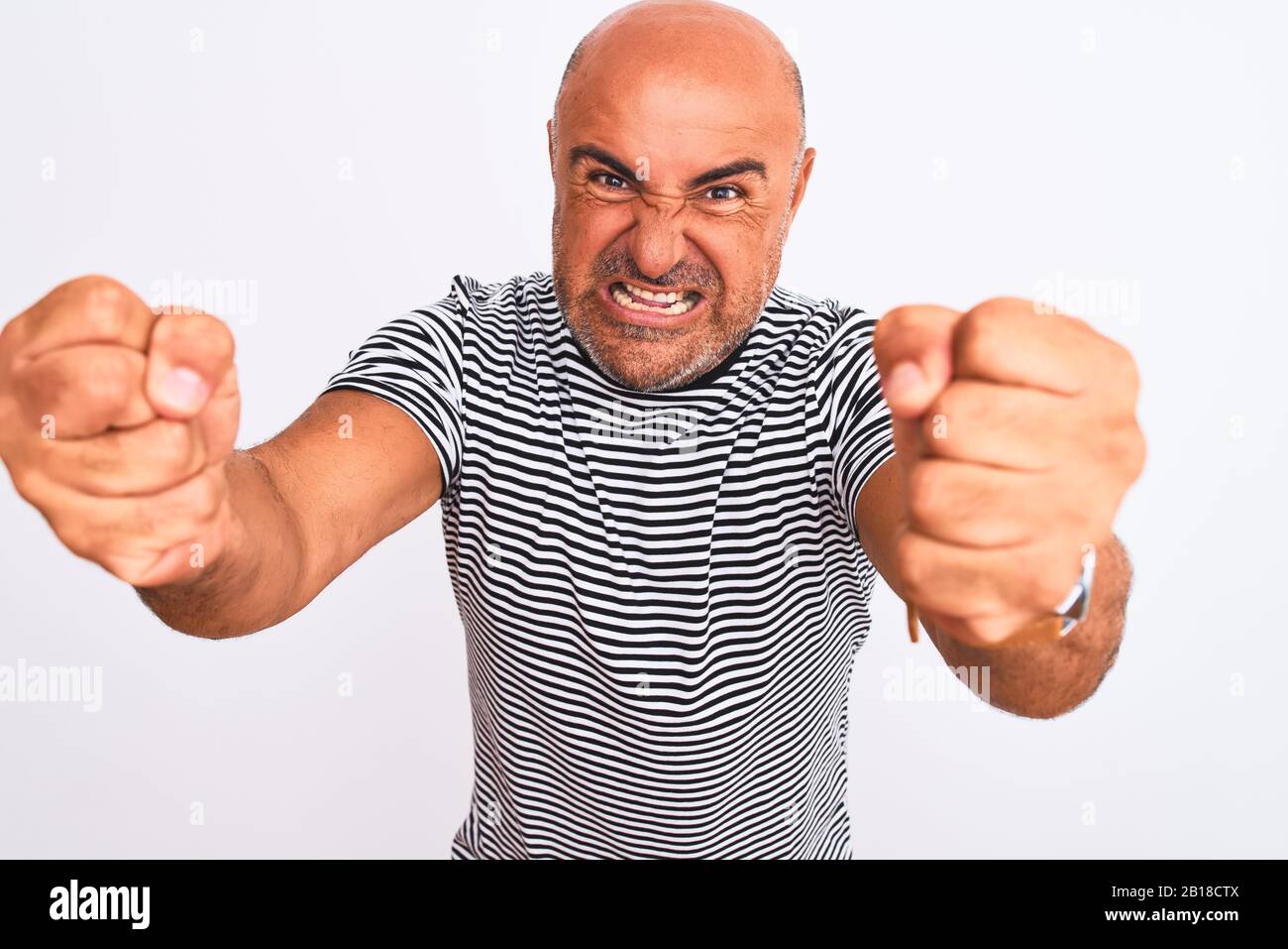 Middle age handsome man wearing striped navy t-shirt over isolated ...