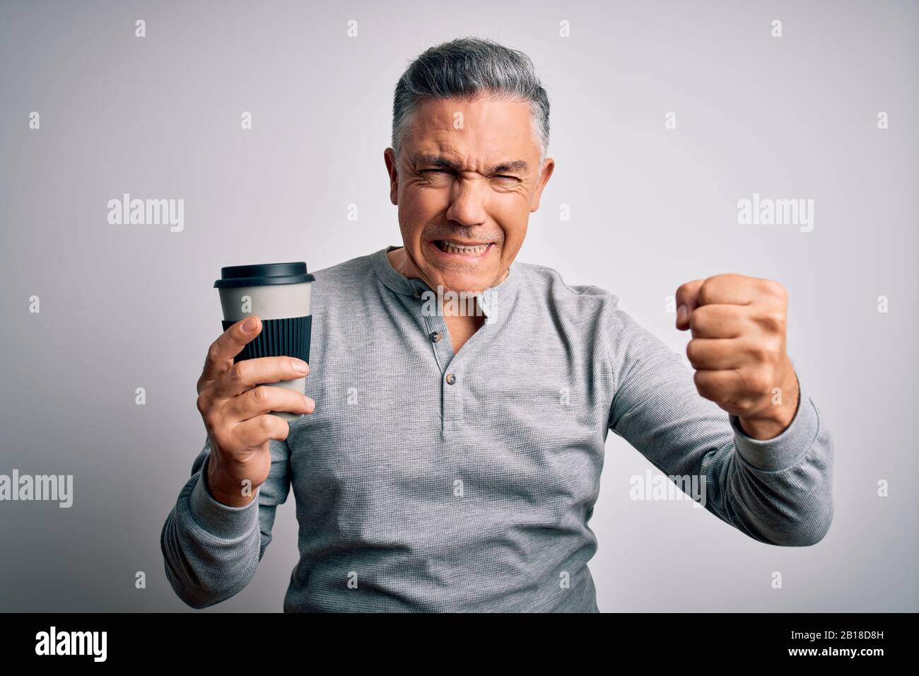 Middle age handsome grey-haired man drinking cup of coffee over ...