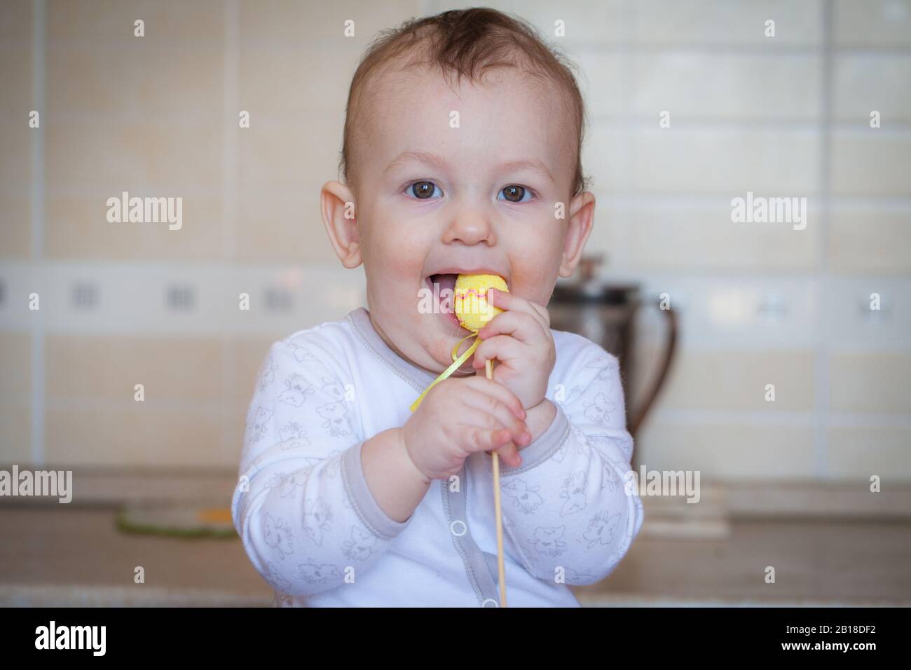 The child eats a cake and smudges his face. Cute baby and appetite ...