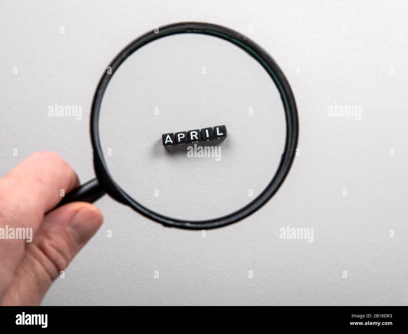 April. Time planning, luck, Easter and a fun day concept. Man's hand ...