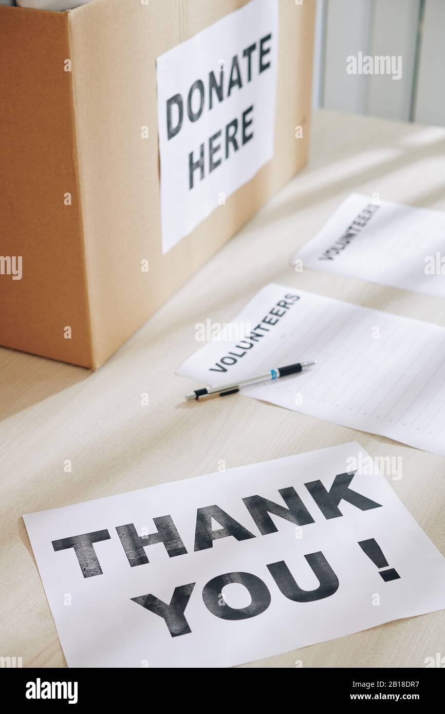 Cardboard box for donations in volunteer center and thank you note ...