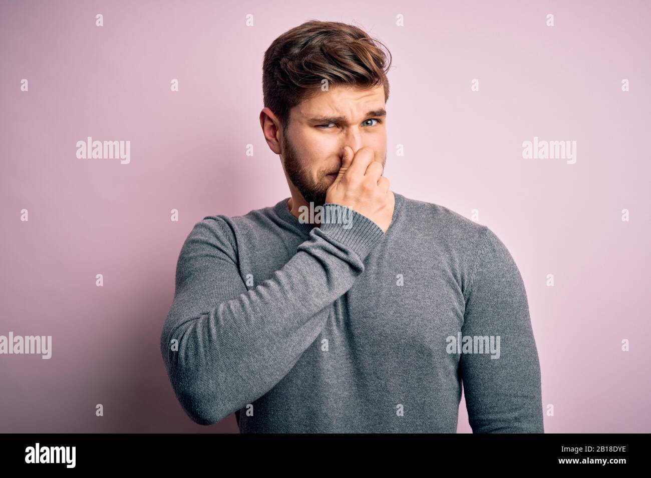 Young handsome blond man with beard and blue eyes wearing casual ...