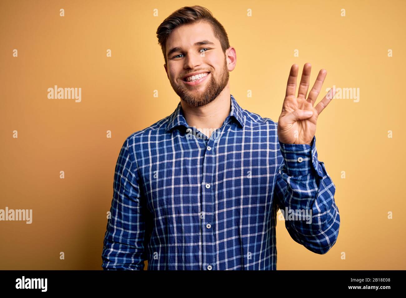 Young blond businessman with beard and blue eyes wearing shirt over ...
