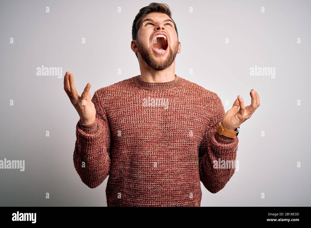 Young blond man with beard and blue eyes wearing casual sweater over ...