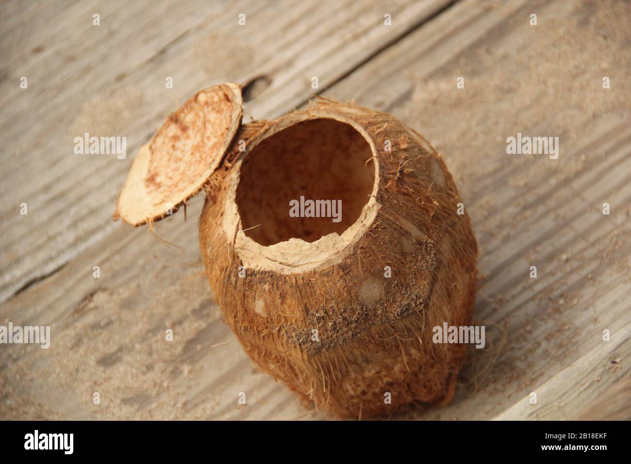 Open coconut in a wooden floor Stock Photo - Alamy
