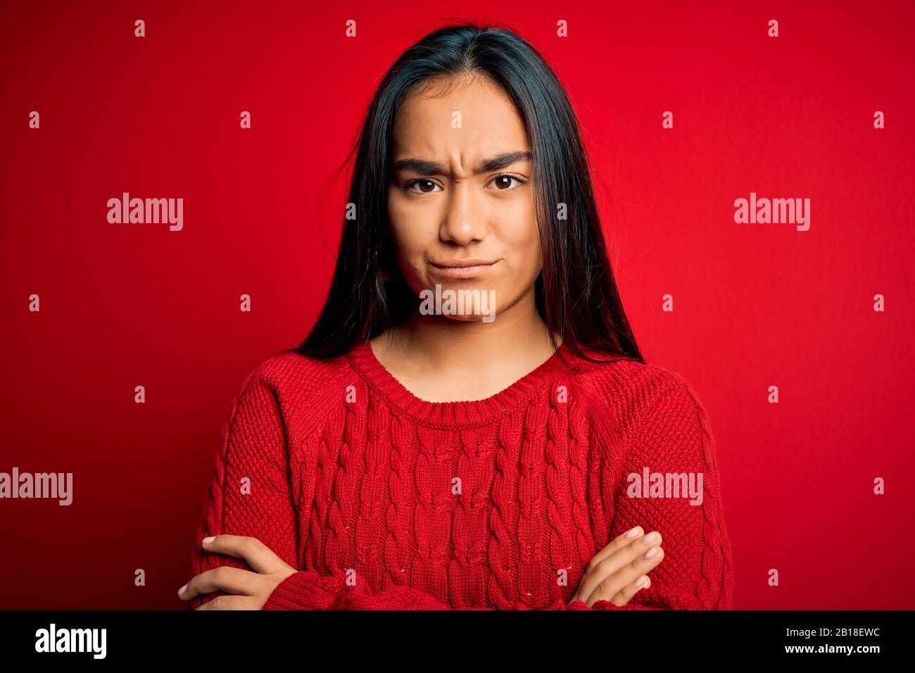 Young beautiful asian woman wearing casual sweater standing over ...