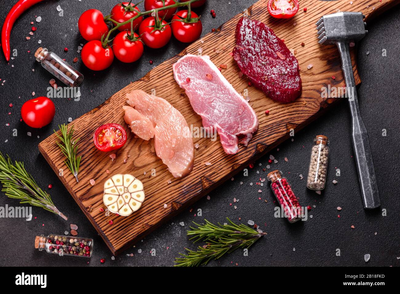 Fresh juicy steak of beef, pork and chicken with vegetables ready to ...