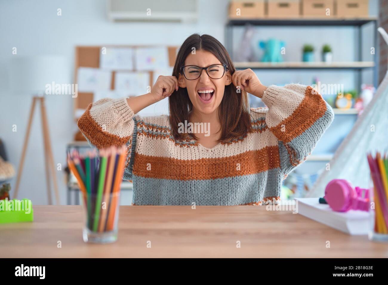 Woman pulling face and desk hi-res stock photography and images - Alamy
