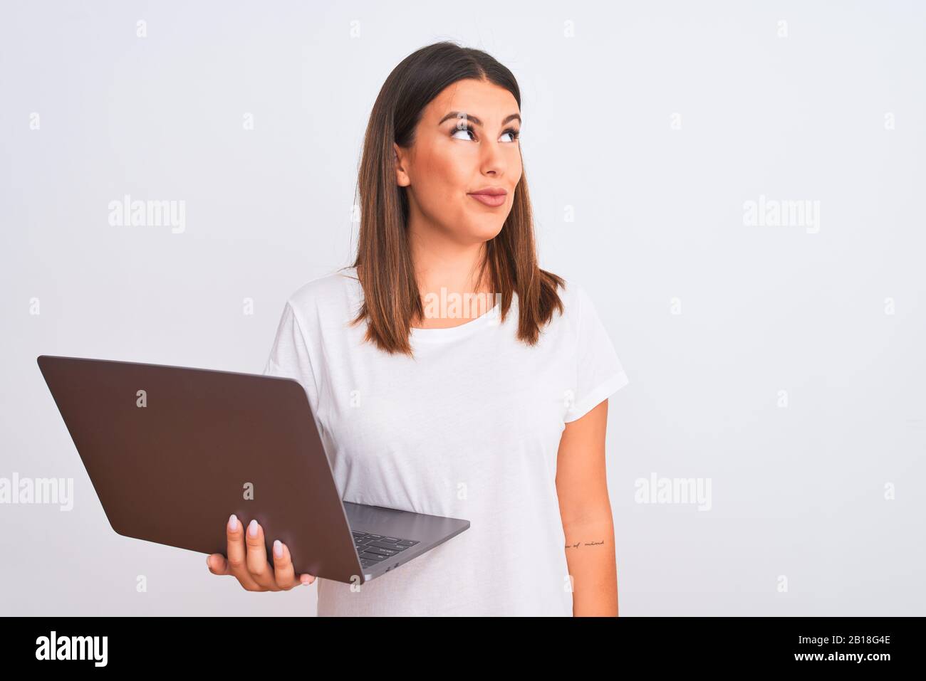 Beautiful young woman working using computer laptop over white ...