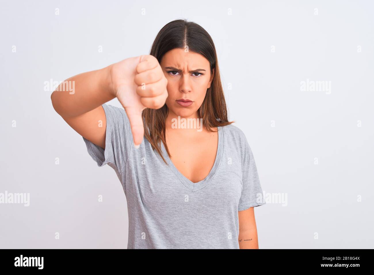 Portrait of beautiful young woman standing over isolated white ...