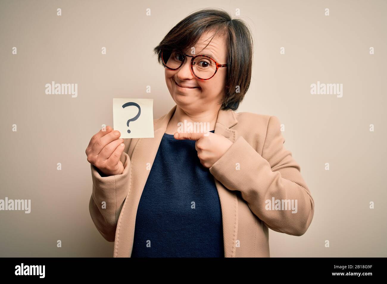 Young down syndrome business woman holding question mark paper as doubt ...