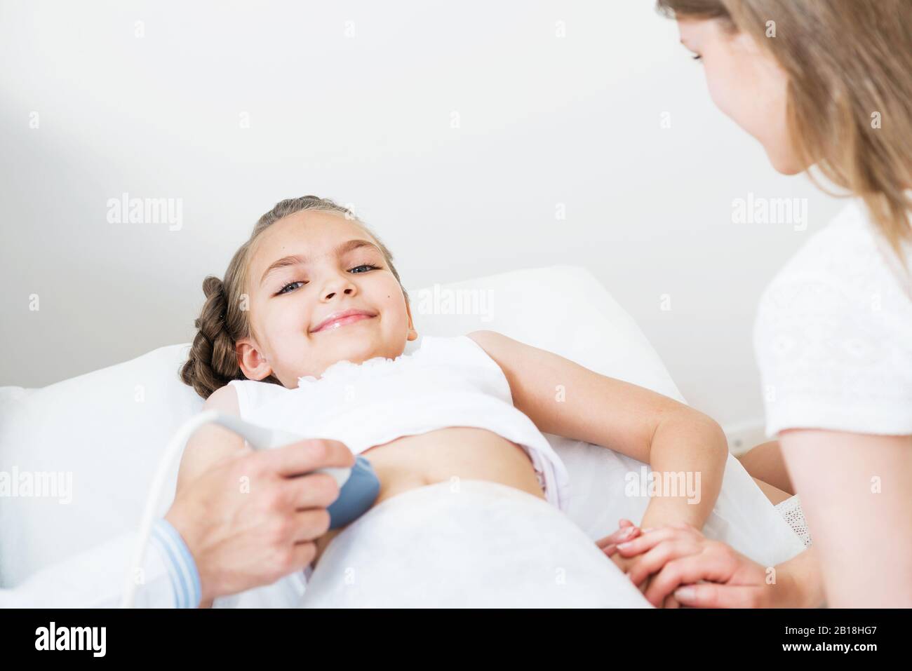 Medical examination of smiling little girl Stock Photo - Alamy