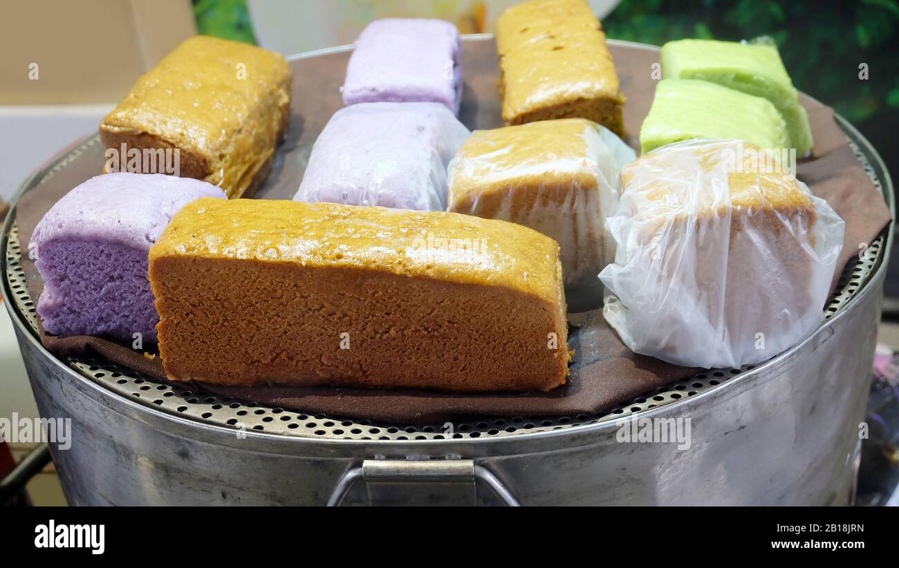 Chinese steamed cake in various colors, on top of a round steamer Stock ...