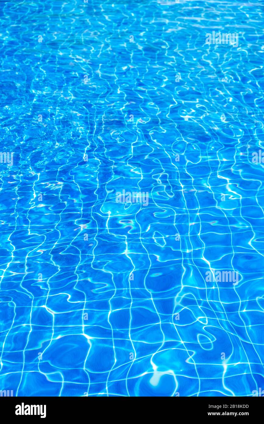 Pure clear ripped blue swimming pool water background, vertical ...