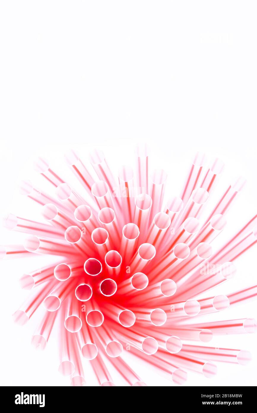 Plastic straws with red and white stripes in a bunch isolated on a ...