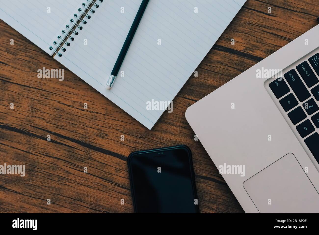 Notebook and computer on brown wood floor Stock Photo - Alamy