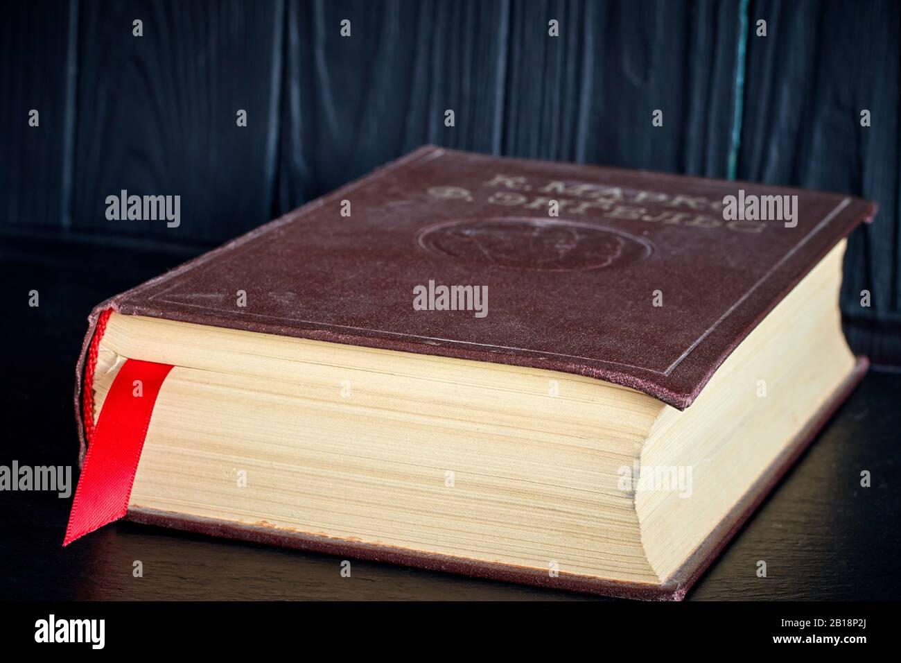 Old Hardback Book On Black Surface With Bookmark Between Pages old-hardback-book-on-black-surface-with-bookmark-between-pages