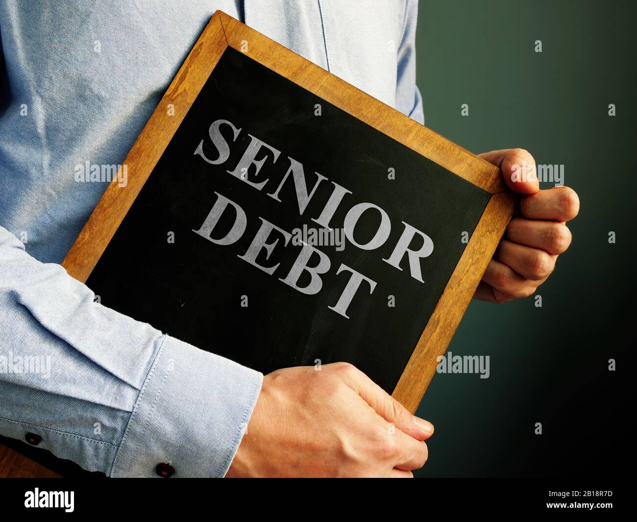 Male is showing Senior Debt sign Stock Photo - Alamy