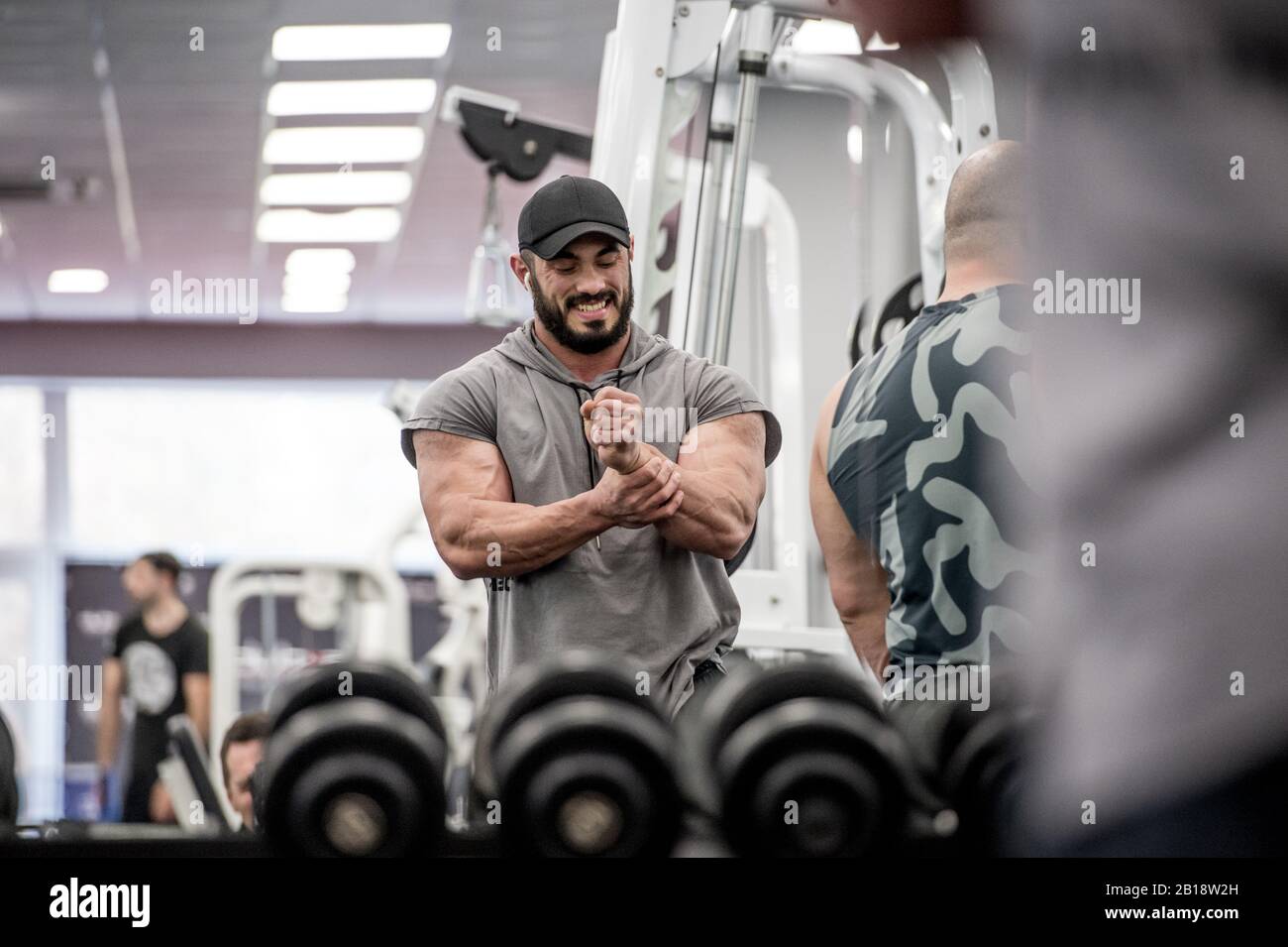 strong muscle bearded man holding his wrist with hand during sport ...