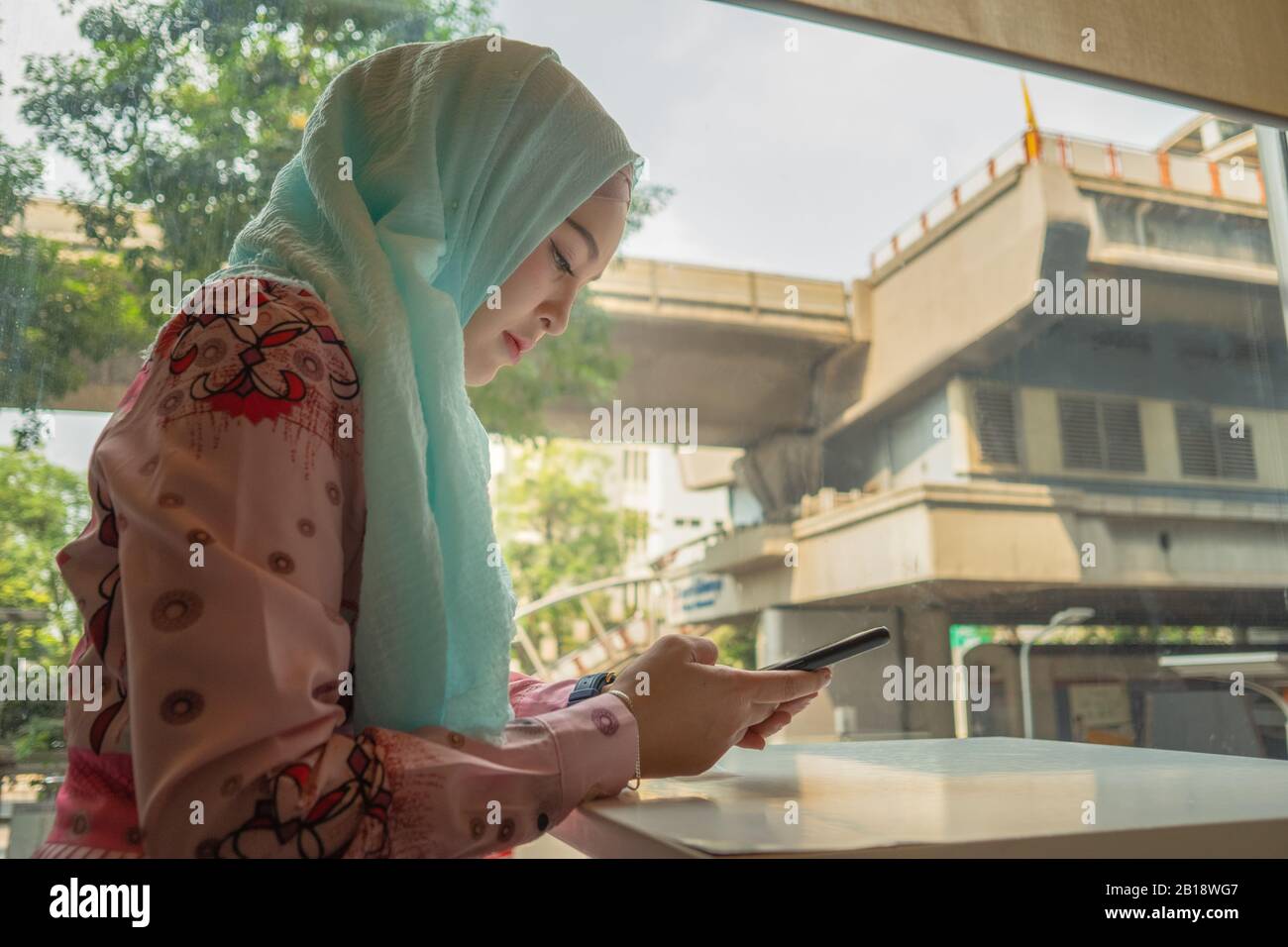 beautiful Islamic girls use mobile phones while waiting for meal Stock ...