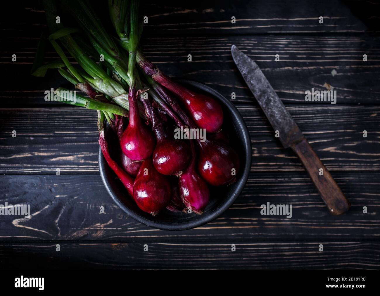 Still life with red onion on rustic wooden background Stock Photo - Alamy