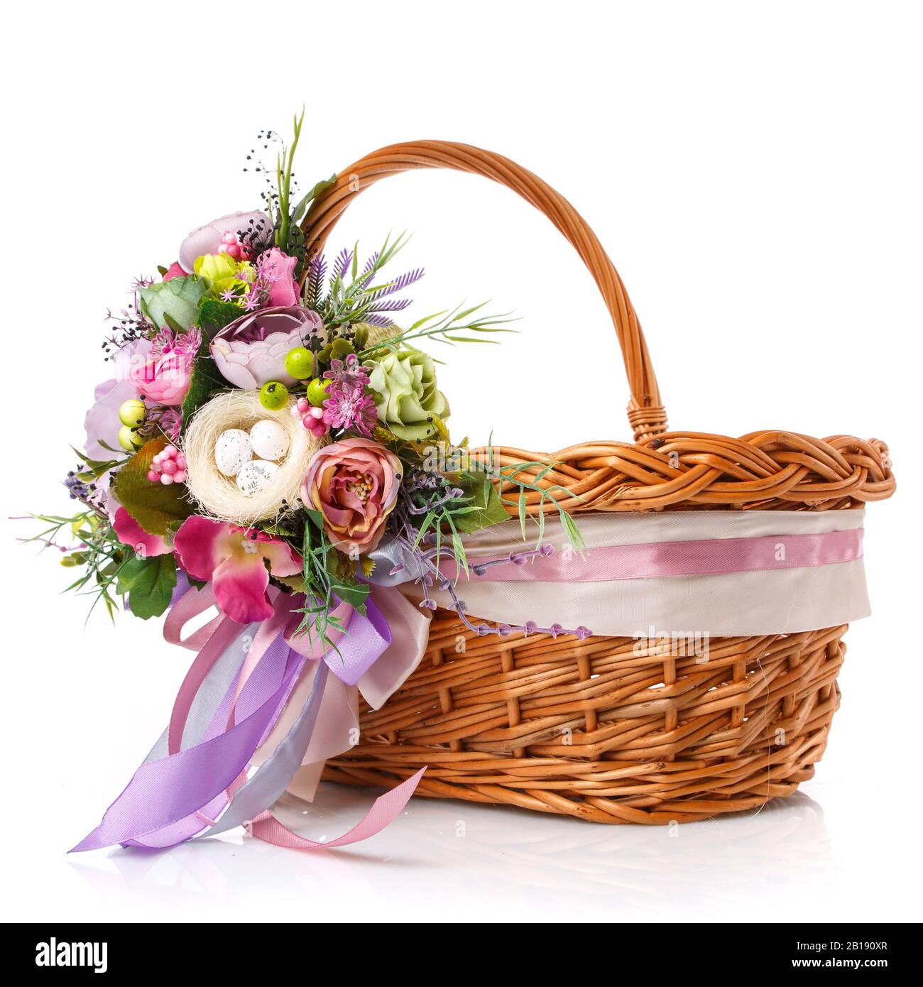 Easter basket. Brown wicker basket with colorful floral decor and ...