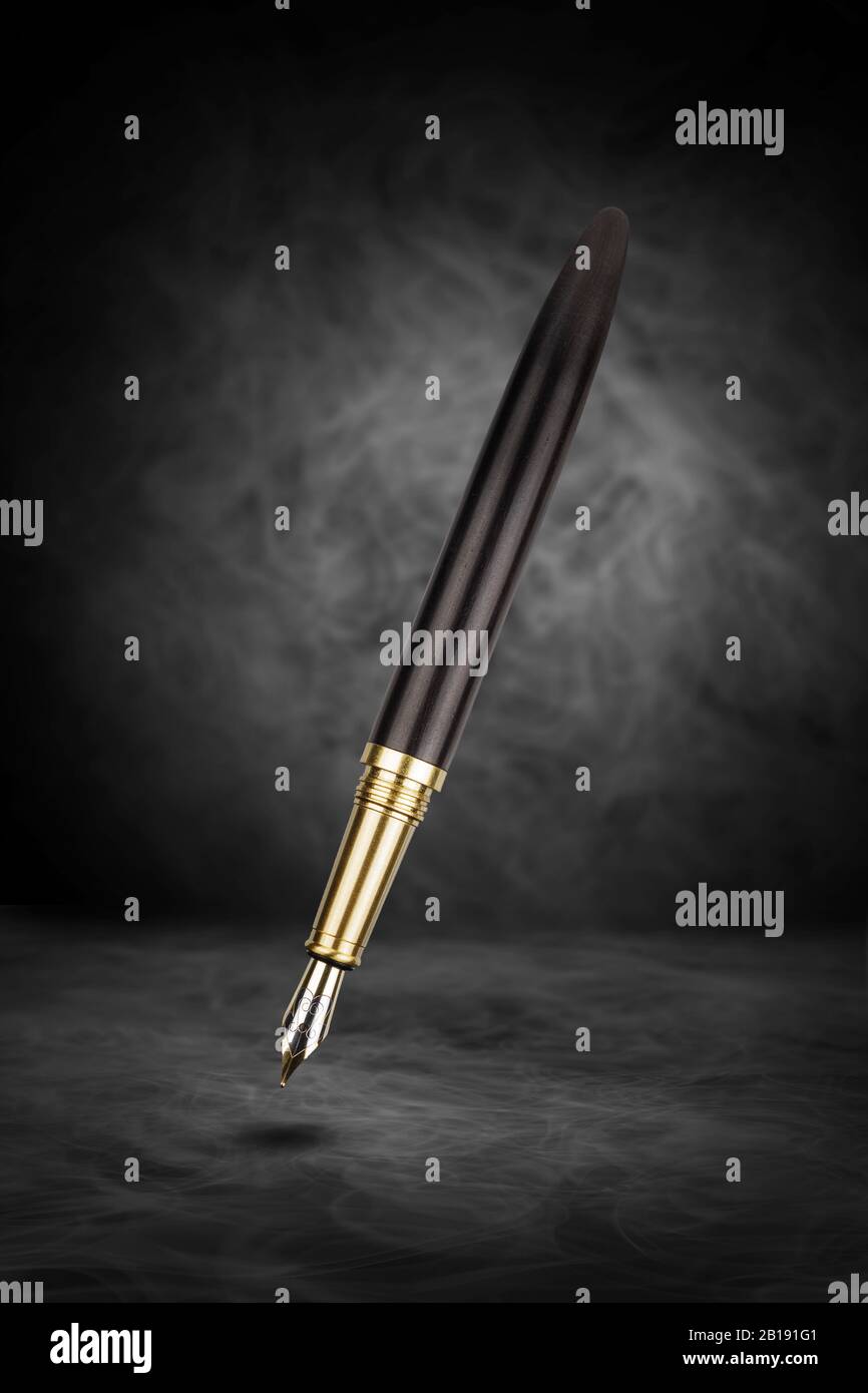 Luxury fountain pen in black on a dark abstract background Stock Photo ...