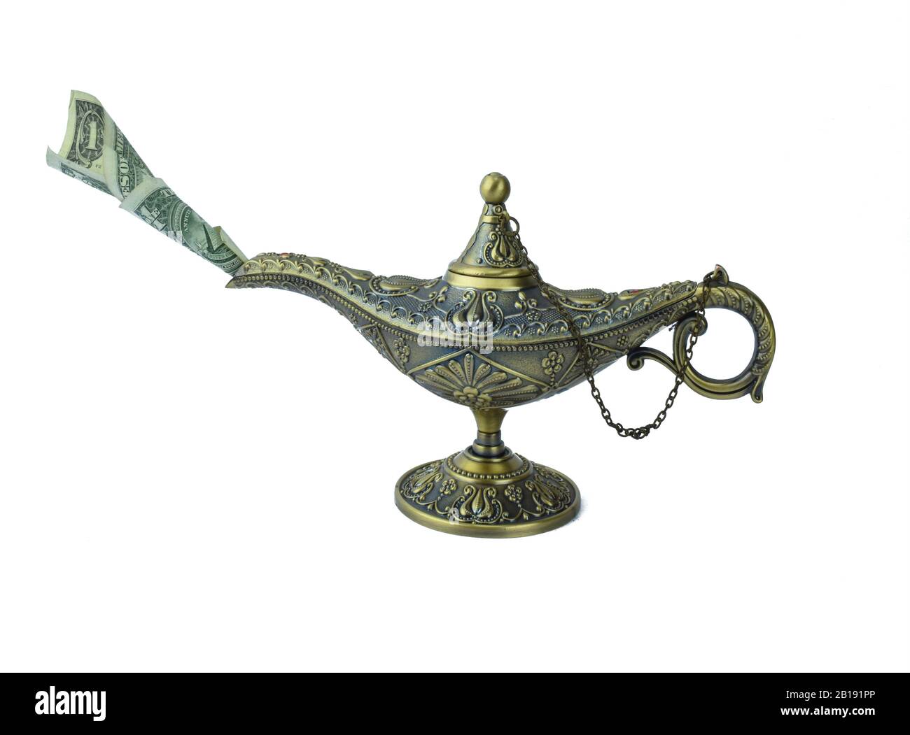 Money flying out of an antique golden colored oil lamp before an ...