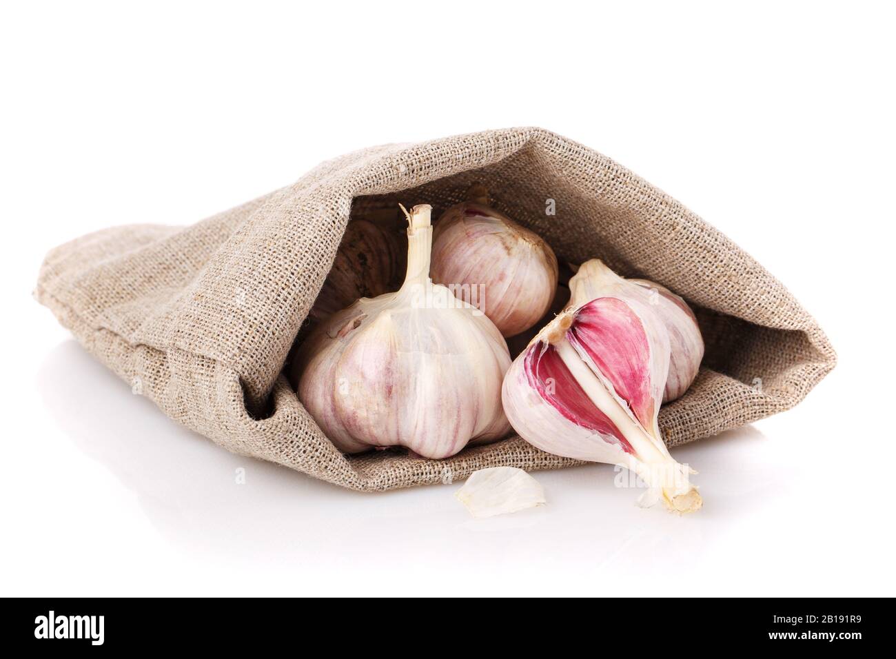 Fresh garlic in burlap bag isolated on white background Stock Photo - Alamy