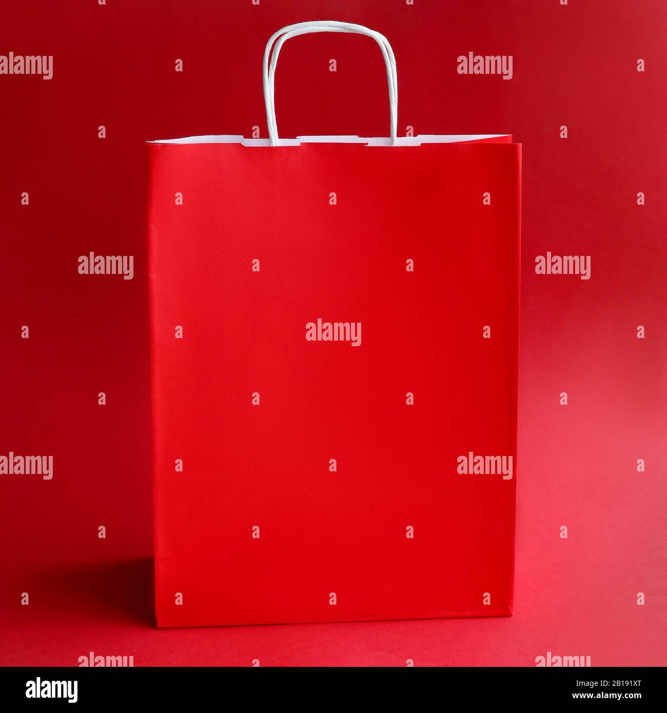 Red paper bag with handles closeup shopping Stock Photo - Alamy