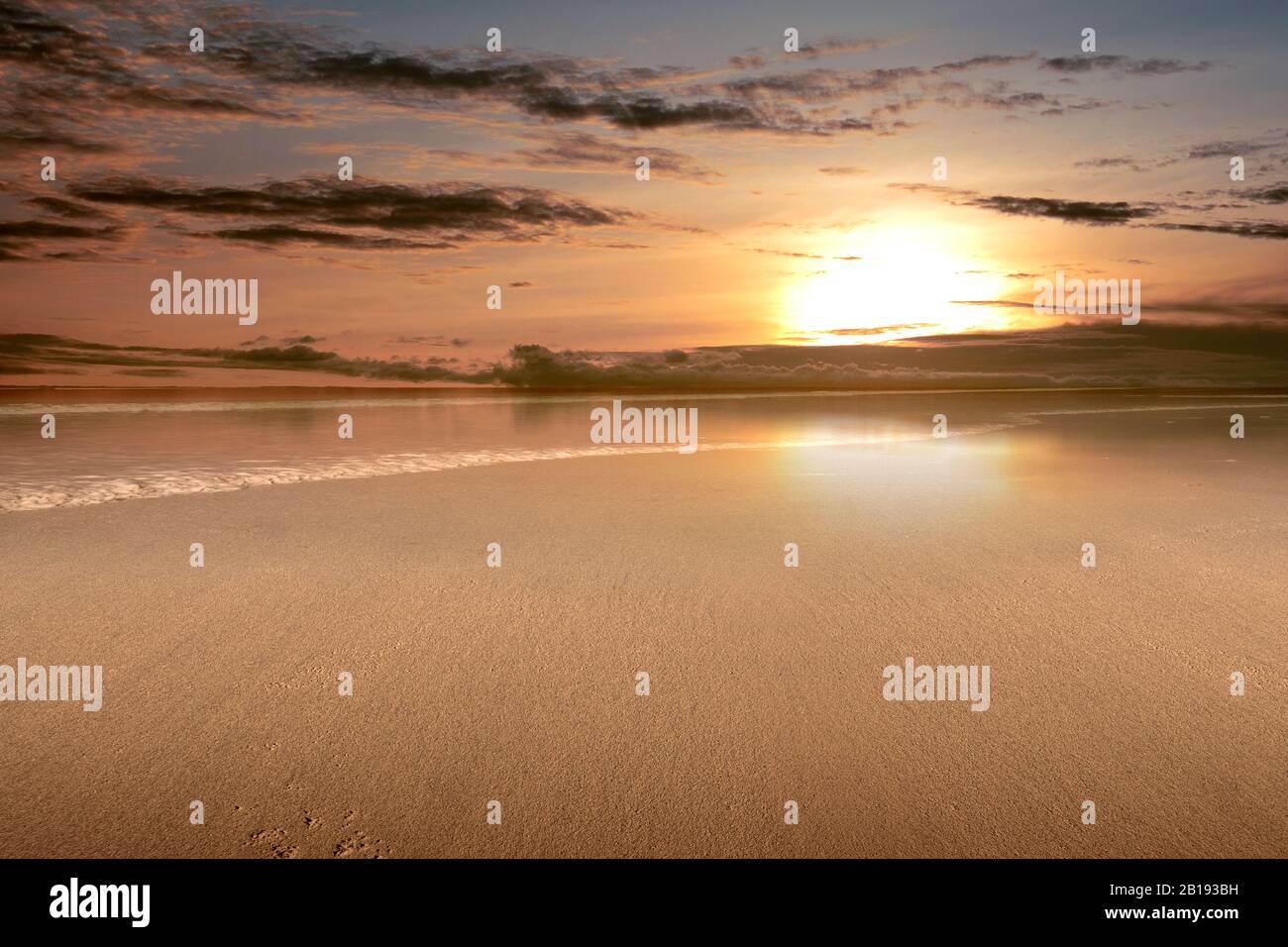 Sandy beach with ocean views with a sunset sky background Stock Photo ...