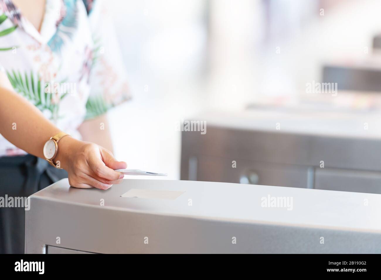Hand using electronic card key for access to entering the turnstile on ...