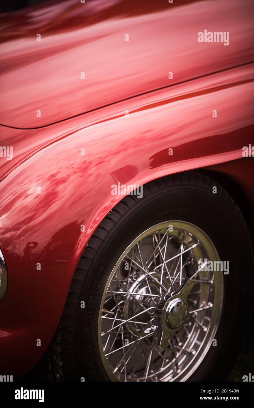 Close up shot of a vintage red classic car spoke wheel Stock Photo - Alamy