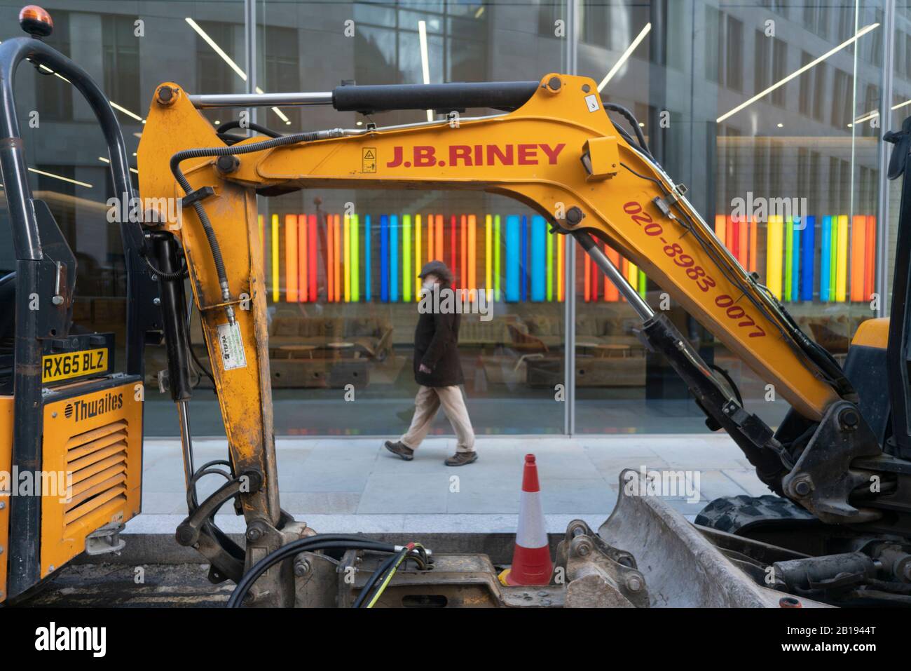 Man Walking Under Construction Digger Stock Photo - Alamy
