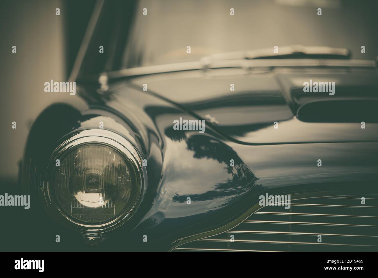 Close up horizontal image of the headlight of a vintage classic car ...