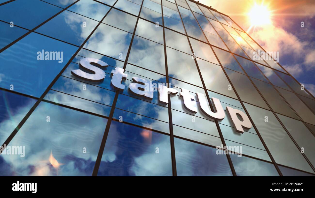 Startup sign on glass building. Mirrored sky and city modern facade ...