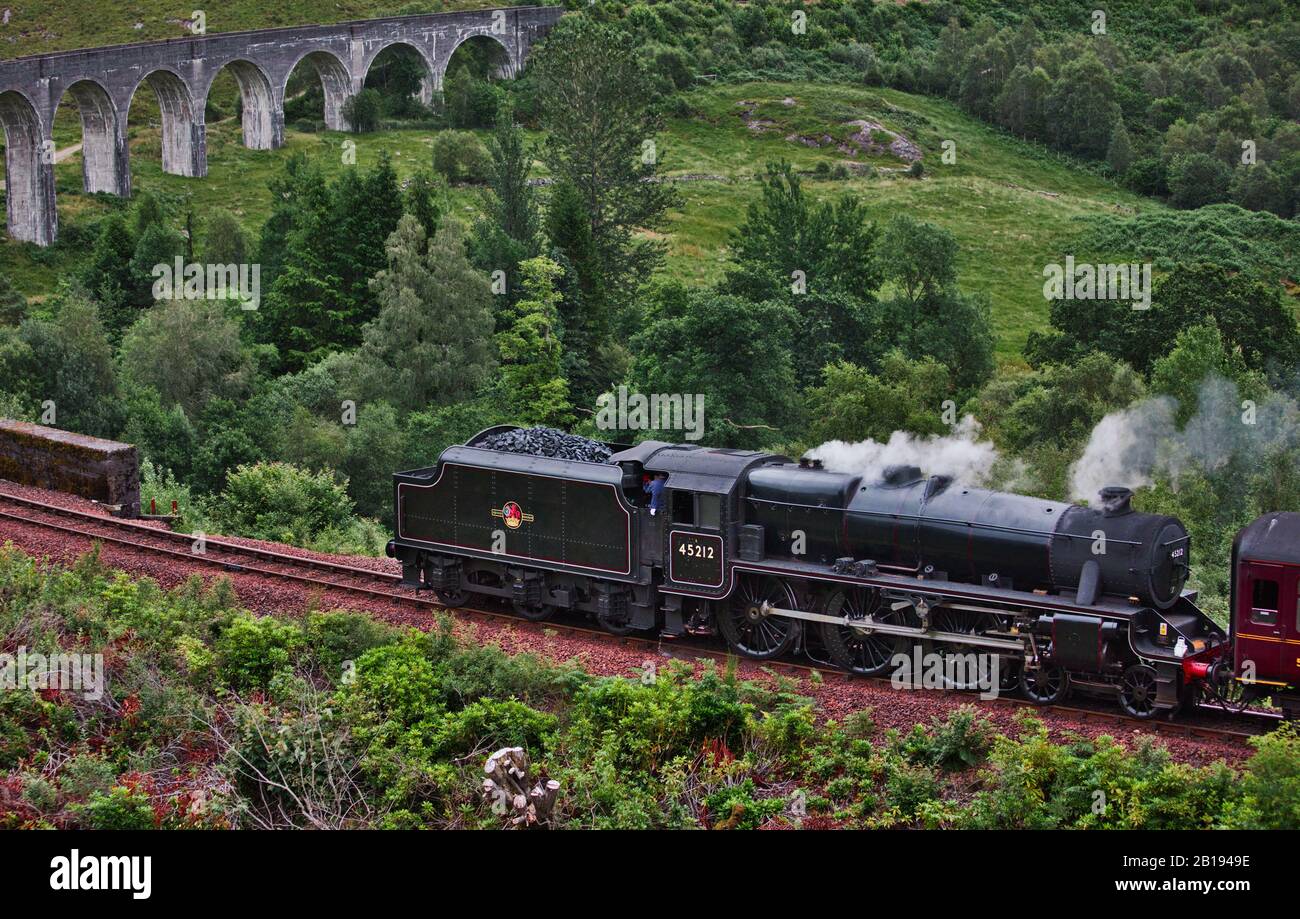 Jacobite steam train blowing steam as it crosses the Glenfinnan Viaduct ...
