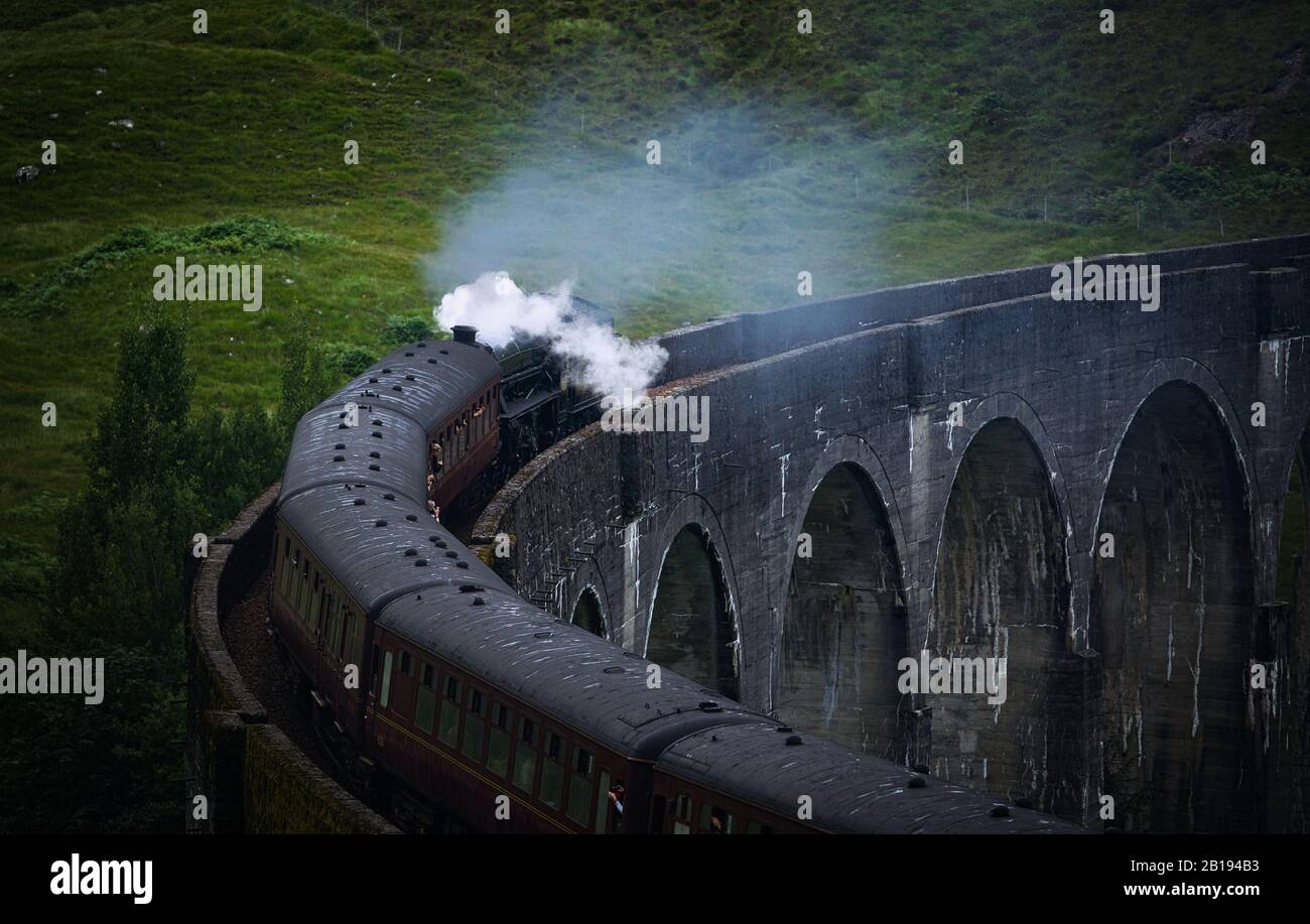 Jacobite steam train blowing steam at it crosses the Glenfinnan Viaduct ...