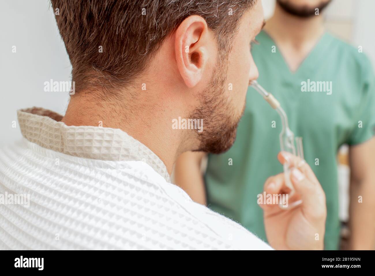 Nasal inhalation for essential oil Maholda in nose of man, close up ...