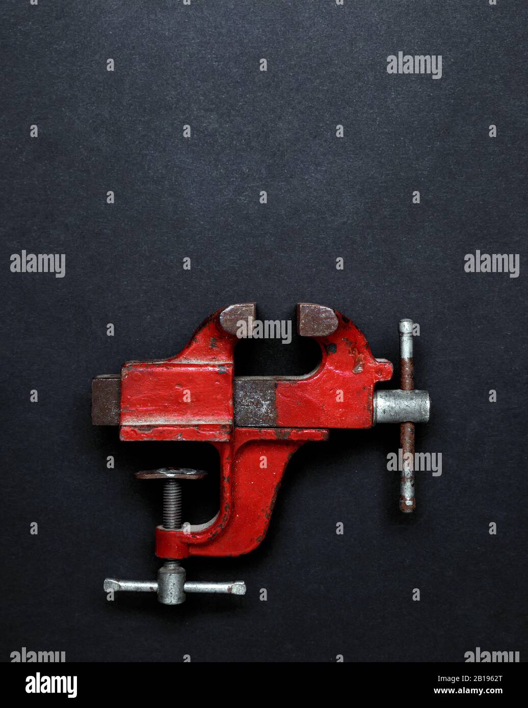 Metalwork tool - red vintage mechanical hand vise clamp on grey ...