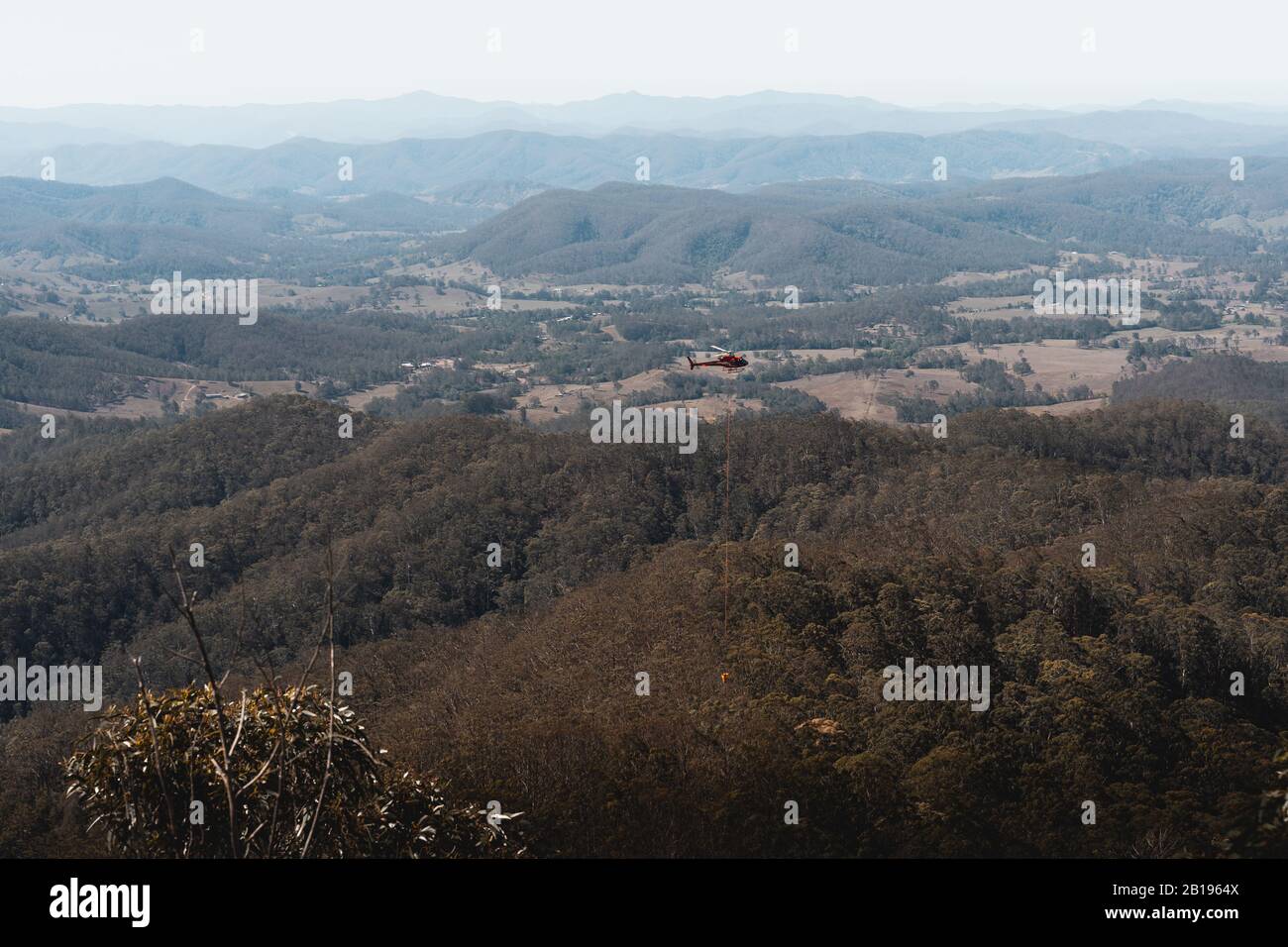 Mount Comboyne - December 30th 2019: A helicopter drops water on a spot ...