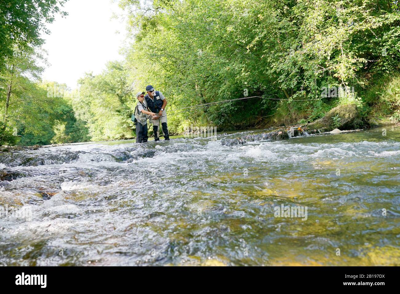 Father and son fly-fishing in river Stock Photo - Alamy
